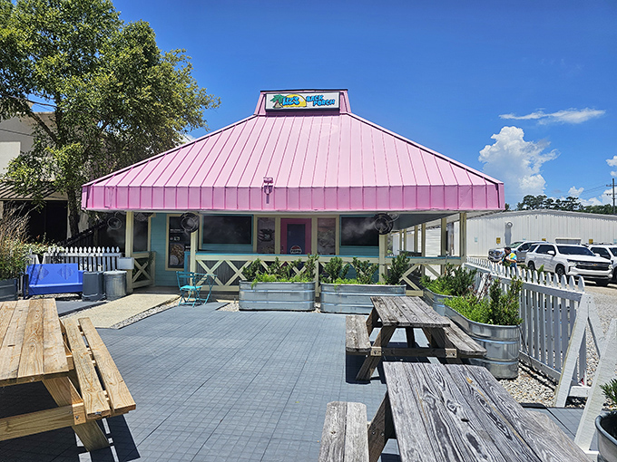 The outdoor seating area with its pink roof stands ready to welcome overflow crowds—because food this good creates lines worth waiting in.