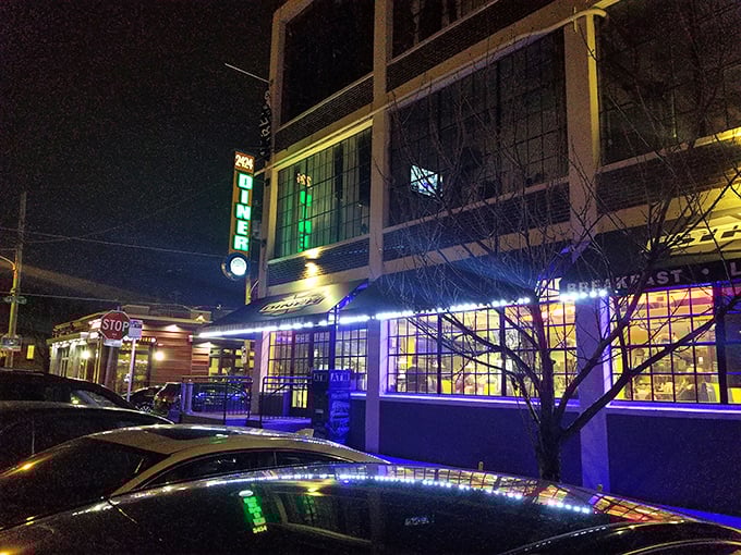 At night, the diner glows like a blue-and-yellow lighthouse, guiding hungry souls through the darkness toward pancake salvation.