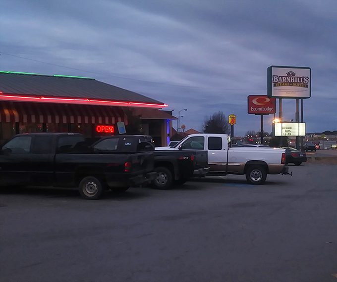 As dusk falls, Barnhill's red neon "OPEN" sign glows like a lighthouse for the hungry. Those trucks in the parking lot tell you everything you need to know.