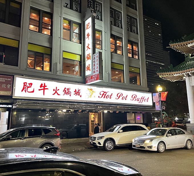 Even at night, Hot Pot Buffet's glow draws hungry pilgrims. The Chinatown gate in the background reminds you this is authentic dining territory.