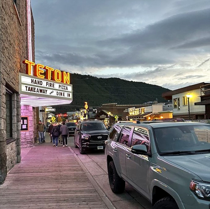Even from the street, you can tell something special is happening inside - the marquee's glow a siren call to pizza lovers.