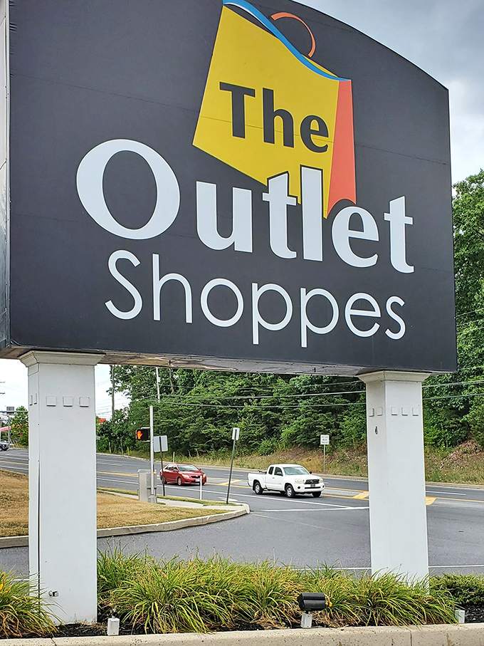 The mall's commanding entrance sign stands like a retail lighthouse, guiding bargain hunters safely to discount shores.