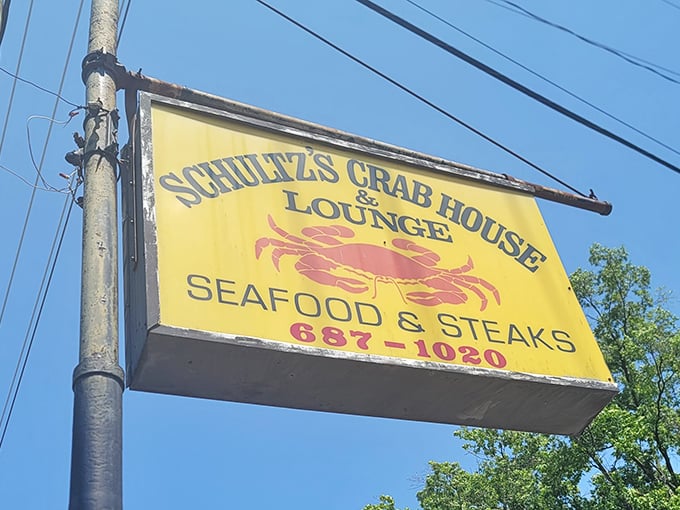 This sign isn't just giving directions; it's promising a taste of Maryland that no fancy harbor restaurant could ever replicate.