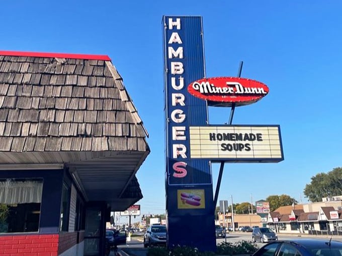 That vertical blue sign has guided hungry travelers for generations. "HAMBURGERS" in all caps is the most honest advertising you'll ever see.