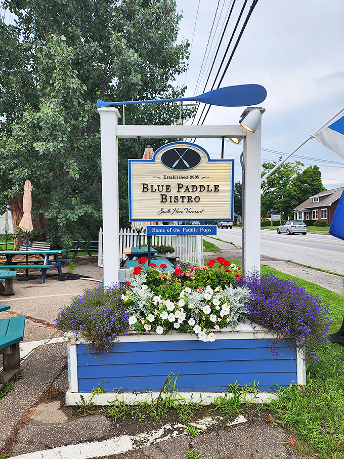 The sign says it all – Blue Paddle Bistro, surrounded by flowers that seem to be celebrating your excellent dining decision right along with you.