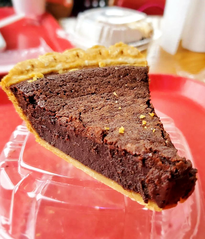 Chocolate pie so rich and dense it should come with its own tax bracket, nestled in a crust that provides the perfect buttery counterpoint.
