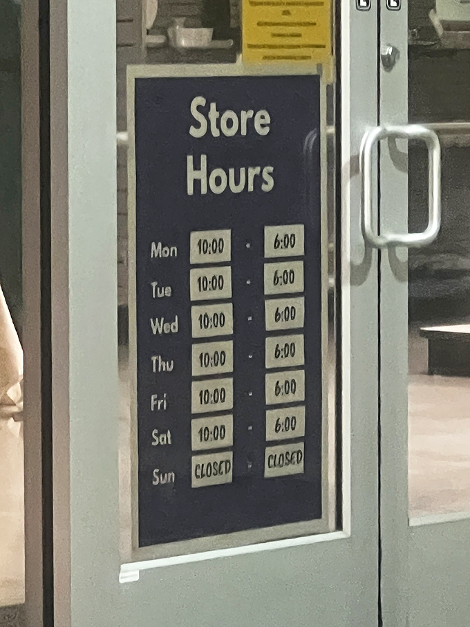 The sacred schedule of savings&mdash;store hours posted with the importance of commandments for the devoted bargain hunter planning their weekly pilgrimage.
