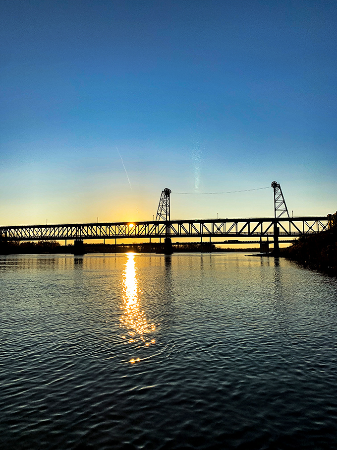 Yankton's historic bridge silhouetted against a sunset sky creates the kind of postcard-perfect moment that makes you forget to check your phone.