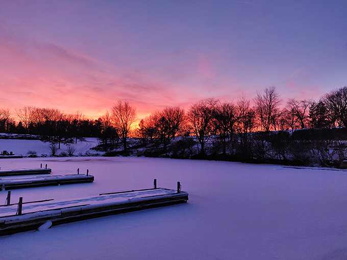 Winter's pink-purple farewell performance over frozen waters – nature's way of saying "stick around, the encore is worth the cold fingers."