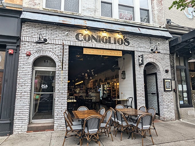 Coniglio's white brick facade is like a time machine with outdoor tables. Classic Italian charm awaits behind those arched windows.