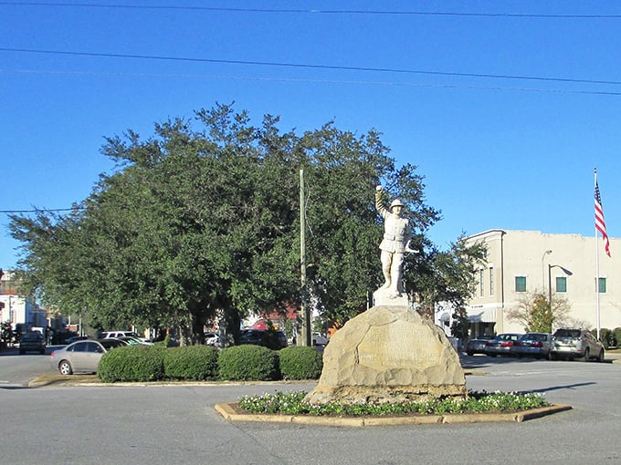 A statue stands proudly in Eufaula's town square, like a sentinel guarding the town's rich history beneath shady trees.