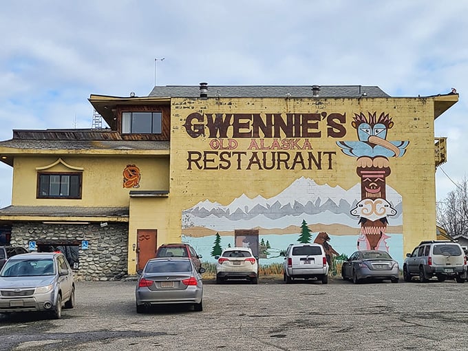That cheerful totem pole mural welcomes you like an old friend waving from Alaska's golden past.