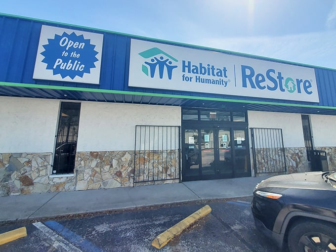 The blue and green Habitat ReStore sign beckons like a treasure map – X marks the spot for furniture gold!