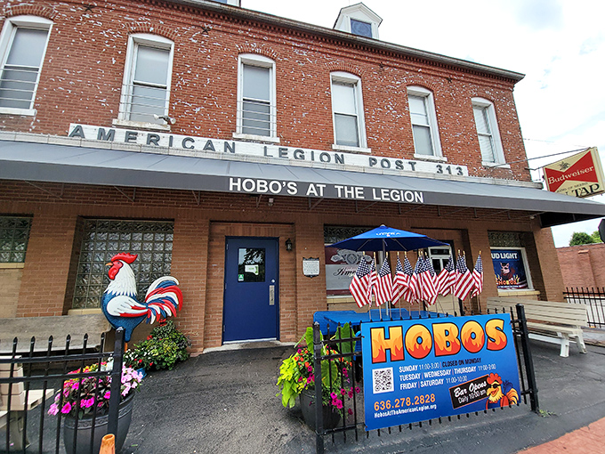 The iconic rooster statue stands guard outside this brick building, promising fried chicken treasures within like a delicious American Legion secret.