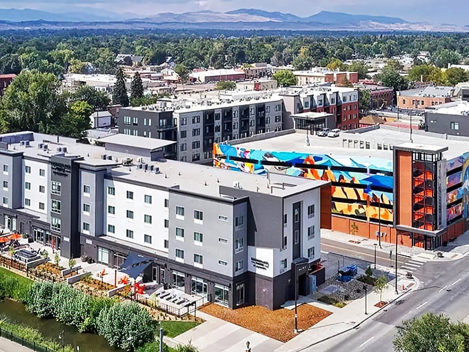 Loveland's skyline stretches toward the mountains, where modern apartments and colorful murals create a vibrant urban-meets-nature vibe.