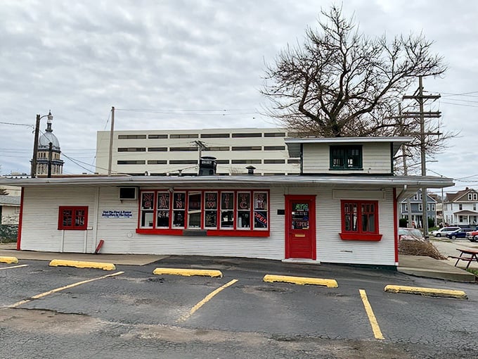 The iconic white building with red trim stands like a time capsule of American sandwich history.