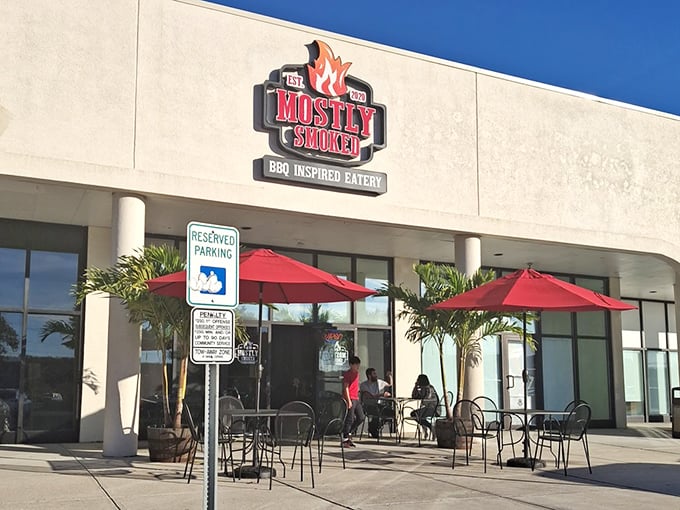The bright red umbrellas at Mostly Smoked beckon like a barbecue oasis in a strip mall desert. Smoke signals of deliciousness ahead!