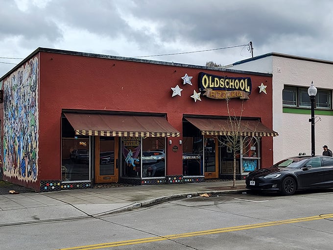 The bright red facade of Old School Pizzeria beckons like a time machine to the golden age of neighborhood pizza joints.