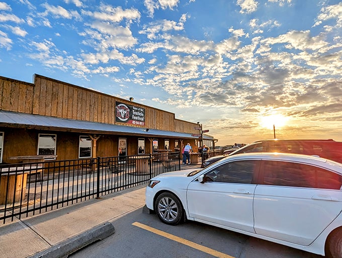 The wooden exterior of Round the Bend Steakhouse glows at sunset, promising carnivorous delights within those humble walls.