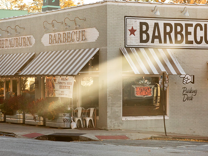 Sweet Auburn's charming brick exterior promises barbecue bliss. That striped awning might as well be a welcome mat for hungry souls!
