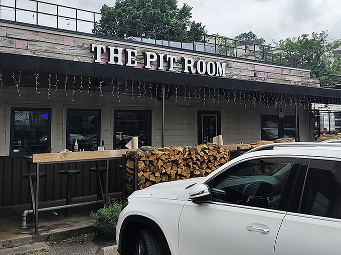 The Pit Room's unassuming exterior hides a world of smoky treasures. That woodpile isn't just for show!