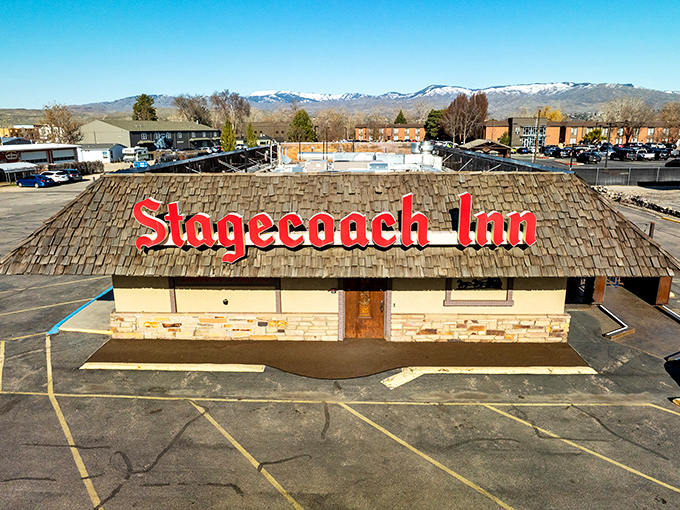 The Stagecoach Inn's iconic wooden-shingled roof and bold red sign stand out like a beacon for hungry travelers.