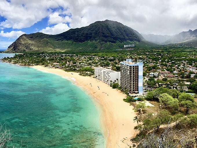 Waianae's coastline looks like a movie set where turquoise waters meet golden sand, with majestic mountains standing guard in the background.