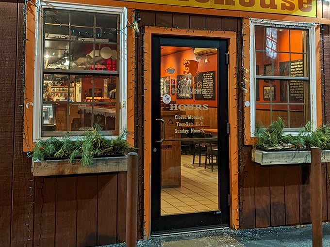 This cozy wooden smokehouse beckons with warm lighting and the promise of mouthwatering BBQ inside.