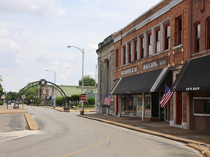 Main Street in Blytheville showcases classic small-town charm with its brick buildings and American flags, a scene Norman Rockwell would have loved to paint.