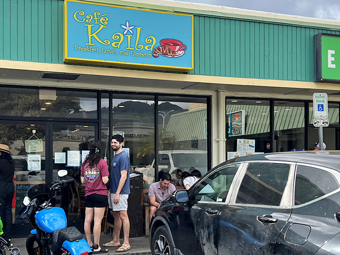 Caf&eacute; Kaila's cheerful sign promises the breakfast trifecta: breakfast, lunch, and espresso. The line forming outside suggests they deliver on all three promises!