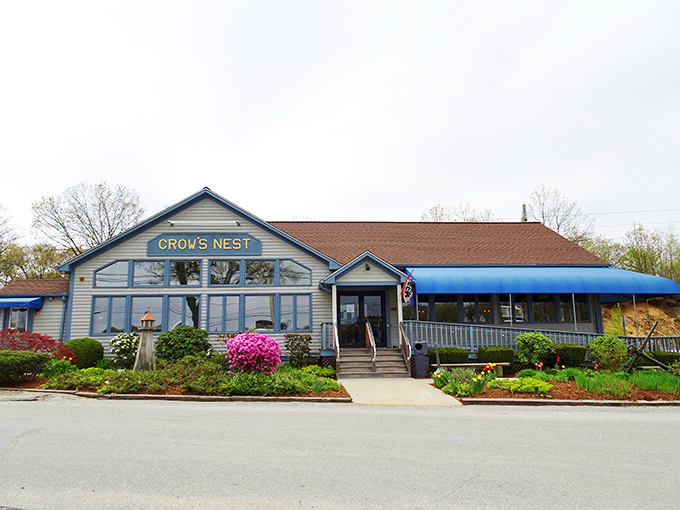 Spring blooms frame the Crow's Nest's inviting entrance, promising seafood treasures inside this beloved Warwick institution.