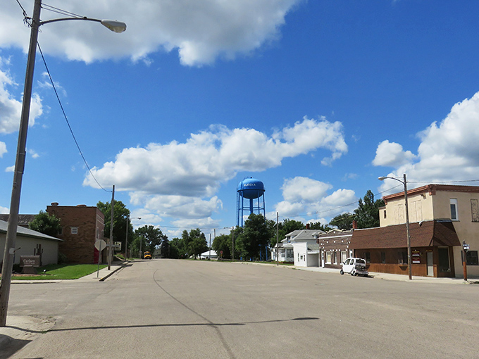 That blue water tower isn't just storing water&mdash;it's keeping watch over a town where your retirement dollars stretch like prairie horizons.