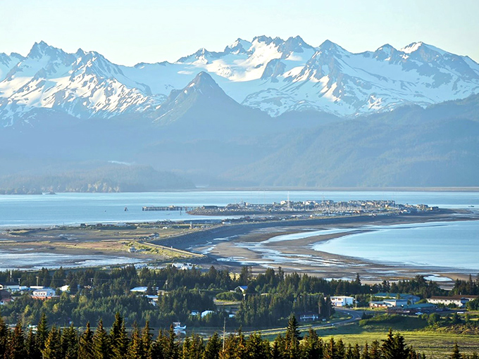 The Homer Spit stretches into Kachemak Bay like nature's welcome mat, with mountains standing guard in the distance.