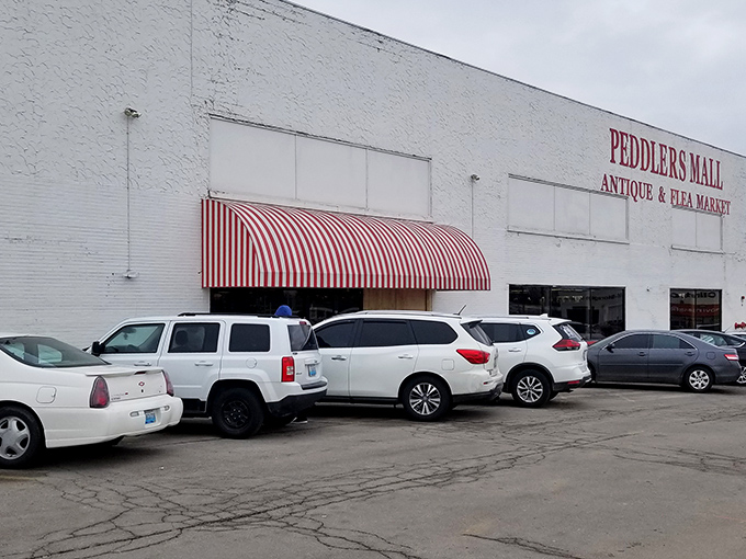 The striped awning welcomes bargain hunters to Peddlers Mall. This unassuming exterior hides a wonderland of vintage finds inside.