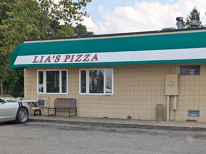 The kind of place where locals gather for no-nonsense, delicious pizza. That classic green and white awning is like a beacon for hungry pizza lovers.