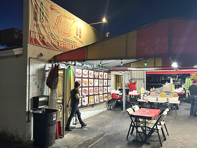 Night falls and Lupita's transforms into hot dog heaven. The menu board promises bacon-wrapped treasures that'll make your taste buds stand at attention.