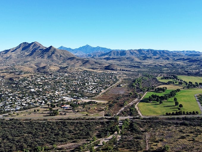 Rio Rico: Desert meets civilization in this breathtaking panorama. Like finding an oasis of homes nestled between nature's most impressive mountain sculptures.