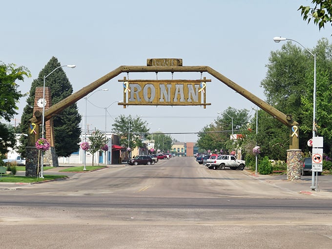Summer transforms Ronan's entrance into a picture of small-town serenity, where the famous wooden gateway frames Main Street's unhurried pace.