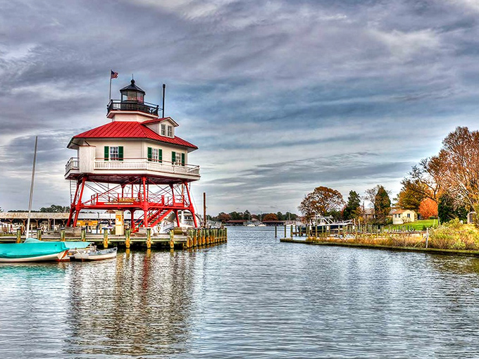 The iconic Drum Point Lighthouse stands guard over Solomons harbor, its distinctive red legs seemingly wading through the calm waters.
