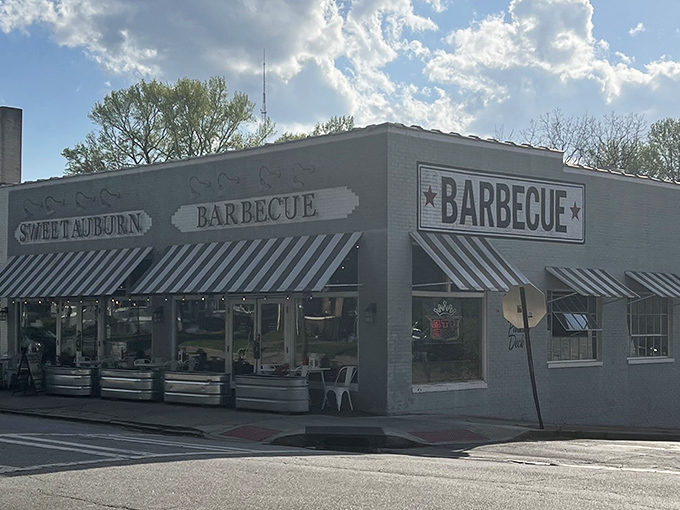 Morning light bathes Sweet Auburn BBQ in a golden glow. This unassuming building houses smoky treasures that'll make your taste buds sing.