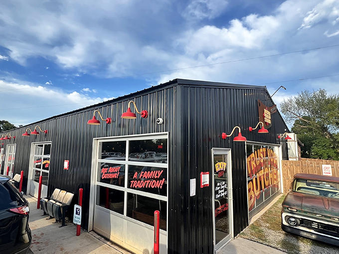 Red lights and a "Family Tradition" sign welcome you to BBQ paradise. This black metal building houses smoke masters who aren't messing around.