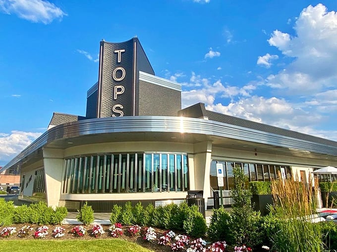 Sunshine bathes Tops Diner's gleaming exterior – a temple of pancakes and meatloaf that's been making Jersey folks happy for generations.