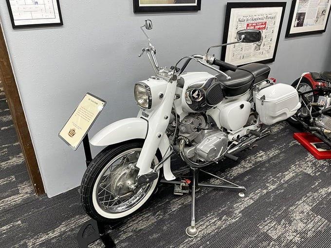 This pristine white 1965 Honda Dream represents the Japanese invasion that forever changed American motorcycling, bringing reliability to a culture that once celebrated breakdowns as character-building exercises.