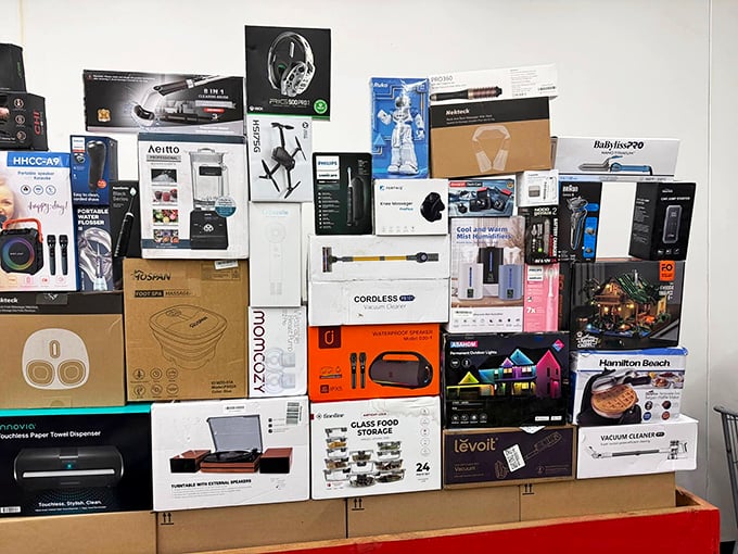 Tech treasures await! From drones to kitchen gadgets, this wall of boxed wonders feels like Christmas morning for adults with bargain-hunting instincts.