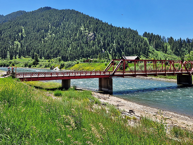 This crimson bridge spans crystal waters where adventure begins, connecting you to wilderness that'll steal your breath away.