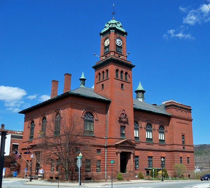 The Claremont Opera House rises majestically in red brick splendor, its copper-topped clock tower a testament to an era when civic buildings doubled as works of art.