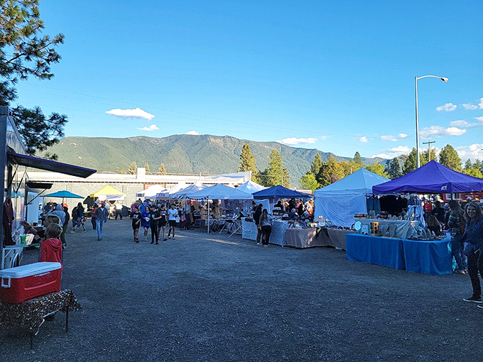 The Community Market buzzes with local energy as mountain shadows stretch across vendors sharing Montana's bounty.