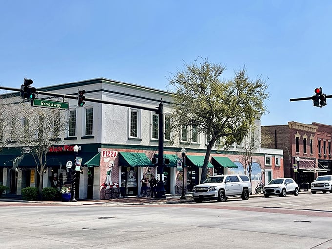 Pizza and history share real estate on this corner of downtown Bartow, where locals gather for slices and conversation under Florida's endless blue sky.