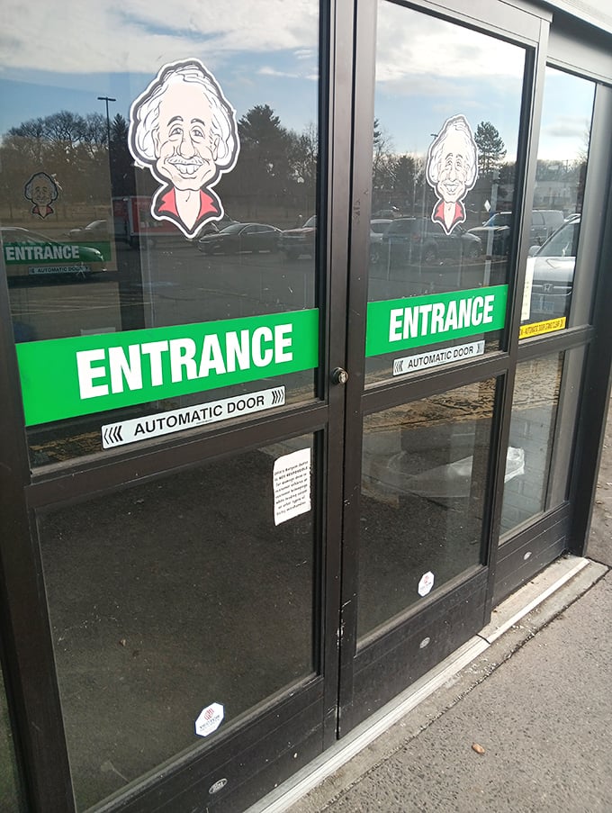 That smiling cartoon mascot welcomes bargain hunters through the green-labeled entrance, like a jolly gatekeeper to a wonderland of discounts.