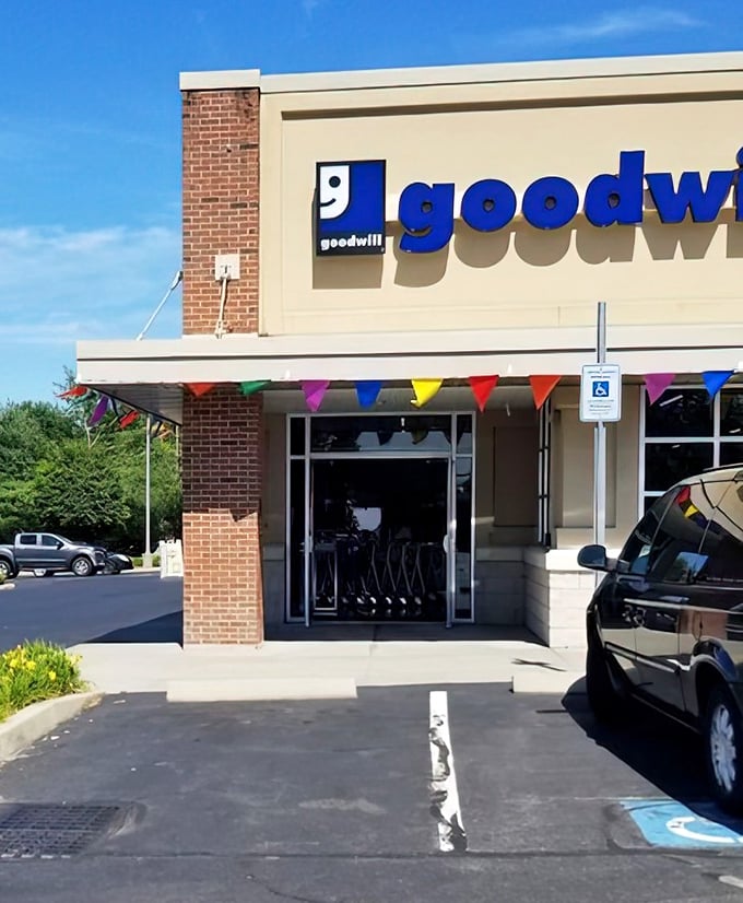 Colorful triangular flags flutter in the breeze, beckoning shoppers inside like the carnival barker of retail therapy.